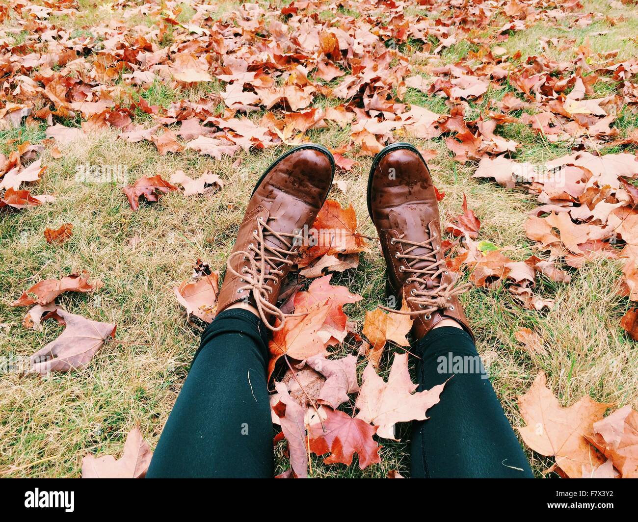 Woman's Boots and Autumn Leaves Stock Photo - Alamy