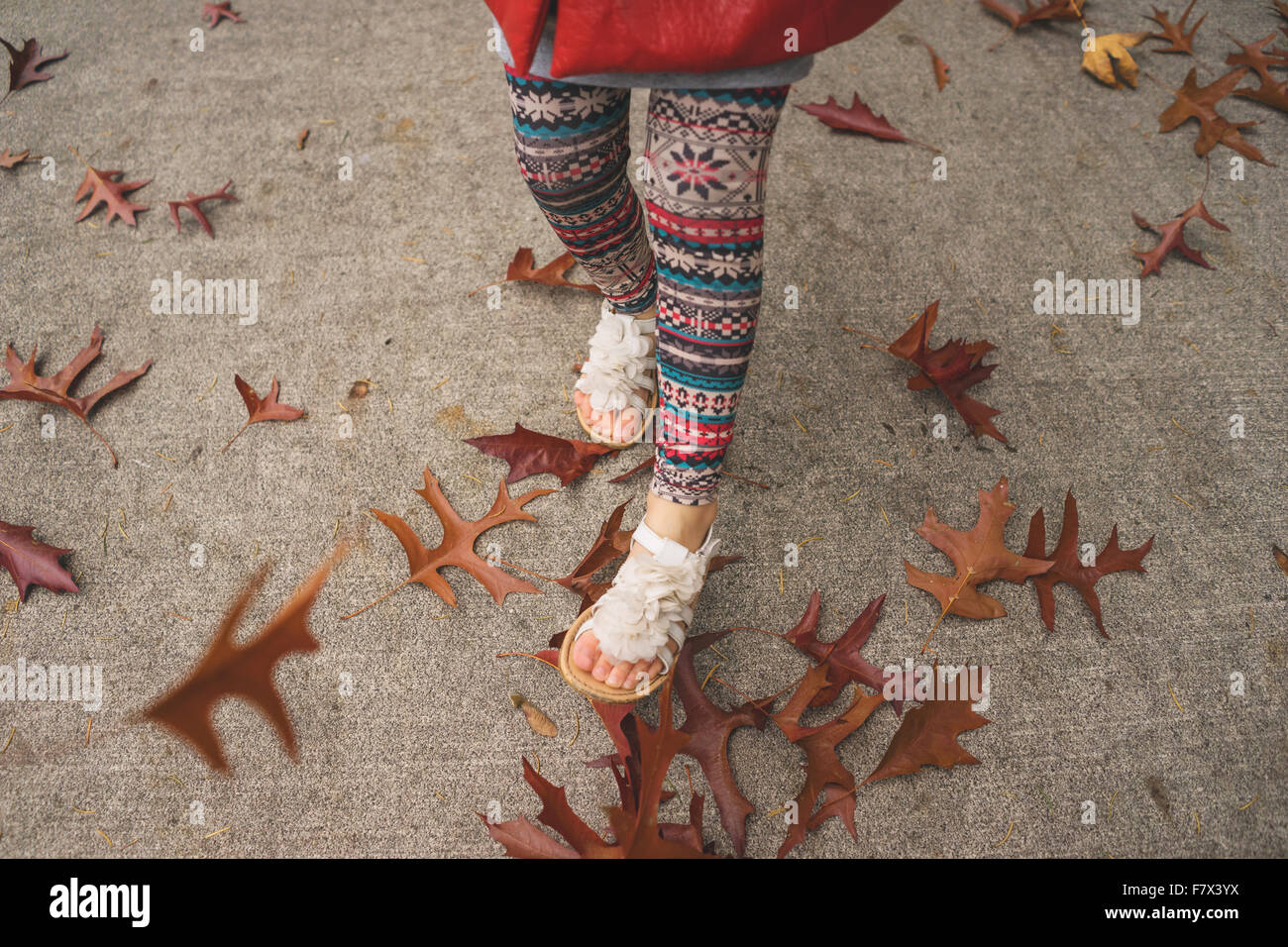Girl skipping along a path in autumn Stock Photo - Alamy