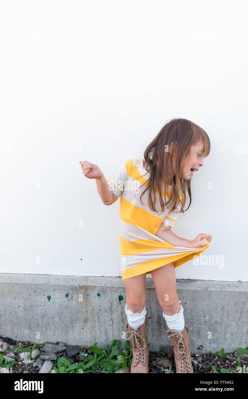 Girl standing outdoors dancing Stock Photo - Alamy