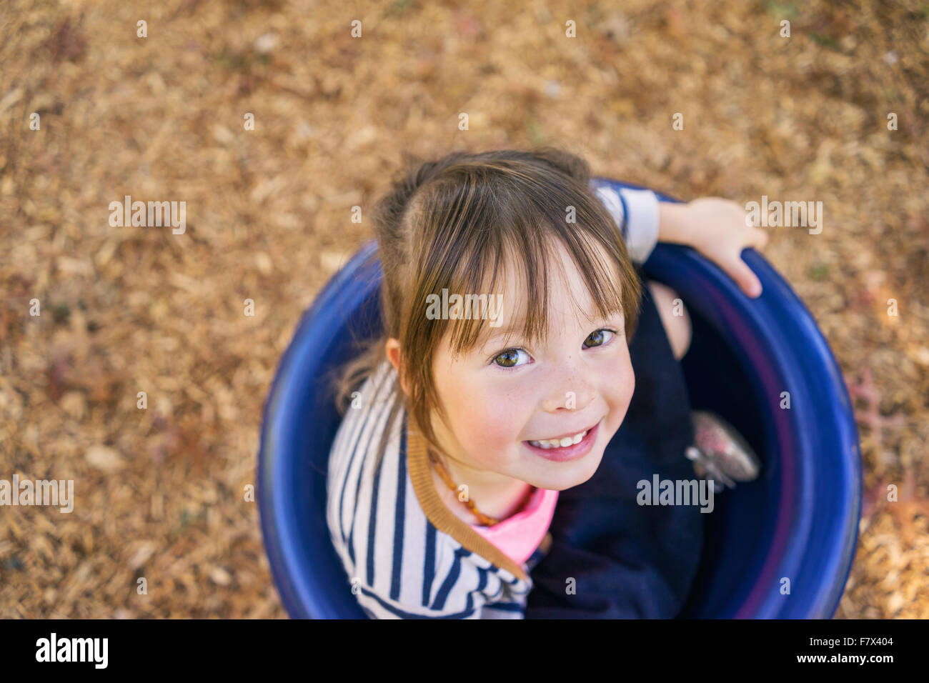 Girl sitting in rubber bucket Stock Photo - Alamy