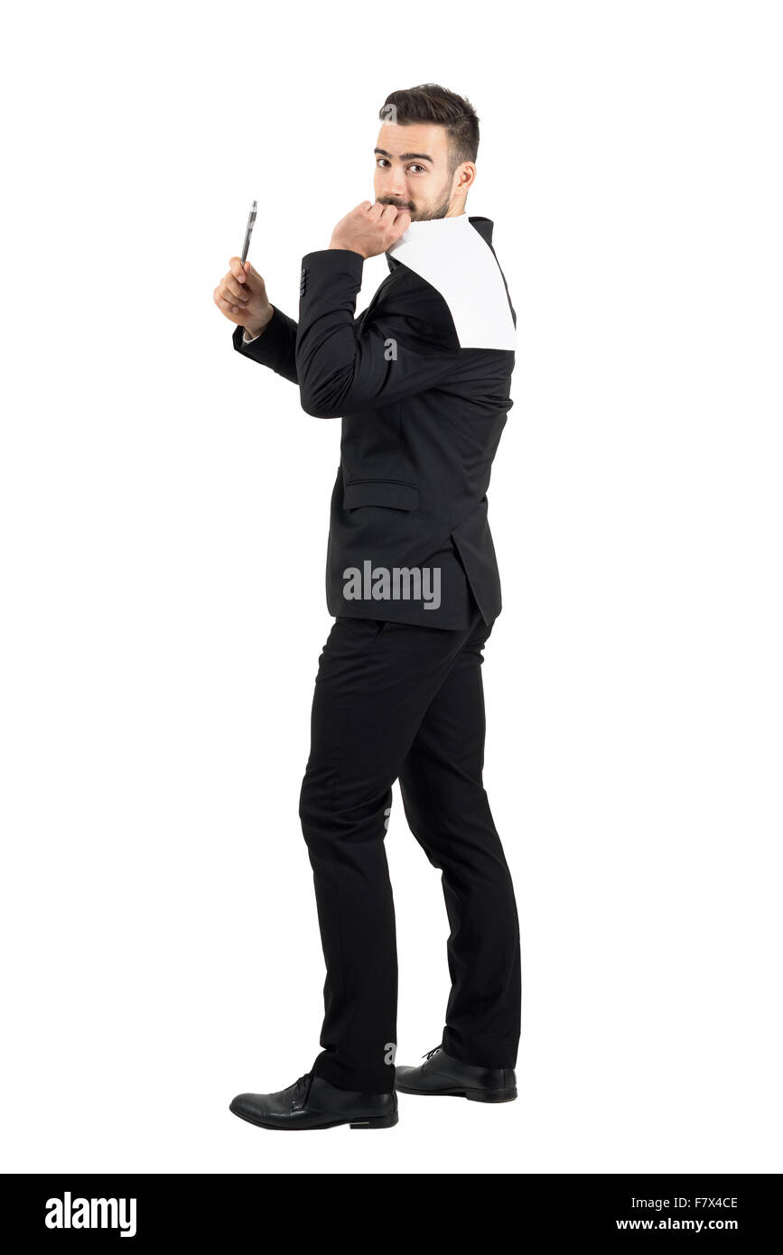 Young business man in suit holding contract paper on his back offering ...