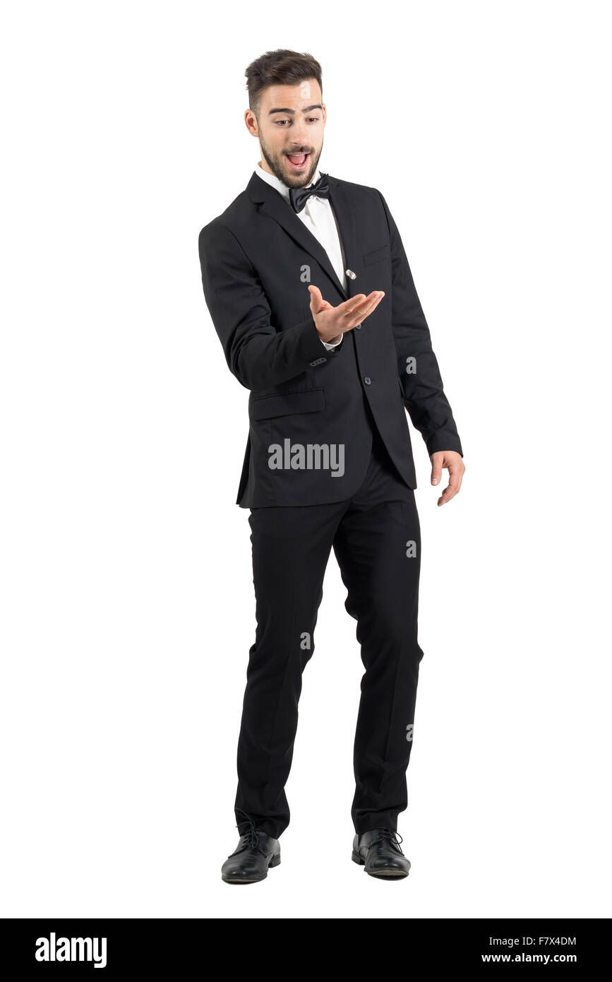 Playful excited young groom tossing wedding ring. Full body length ...