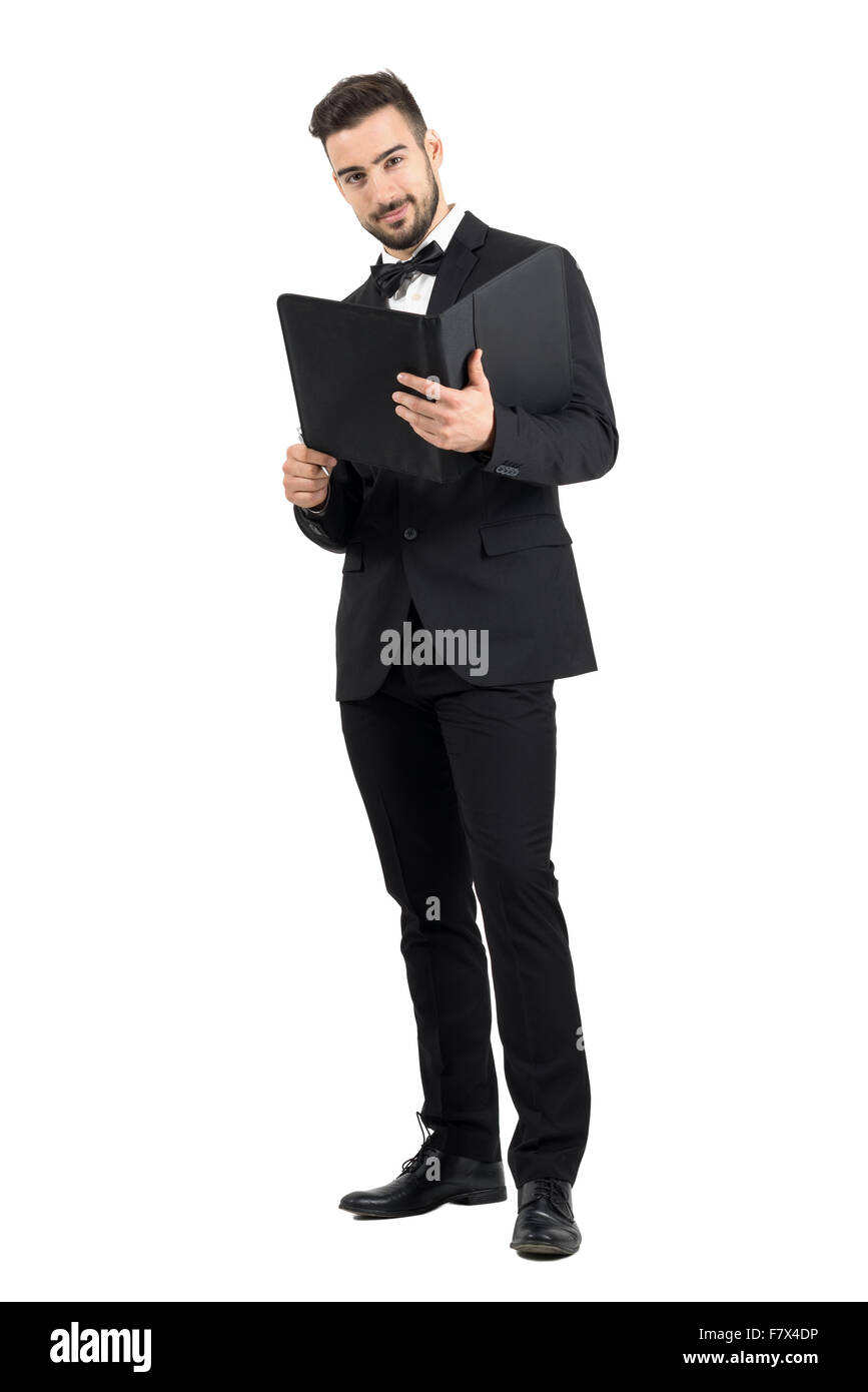 Elegant handsome man in suit reading paper document folder looking at ...