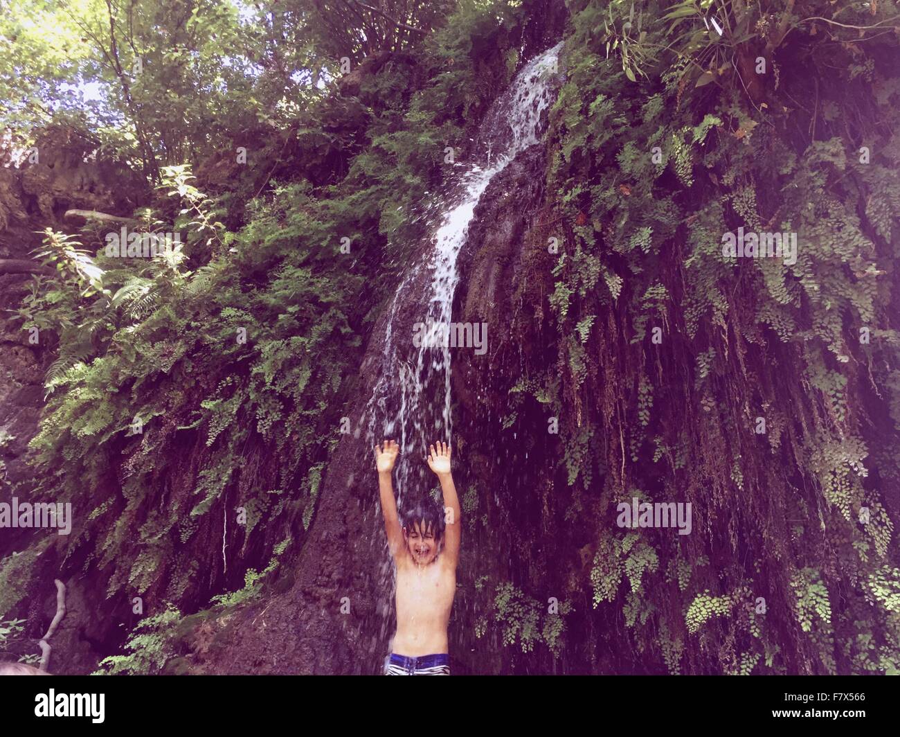 Boy standing under a waterfall, Austin, Texas, USA Stock Photo - Alamy