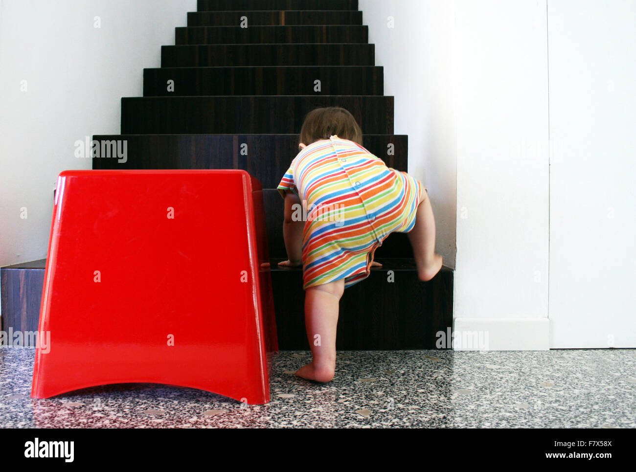 Baby crawling up steps Stock Photo - Alamy