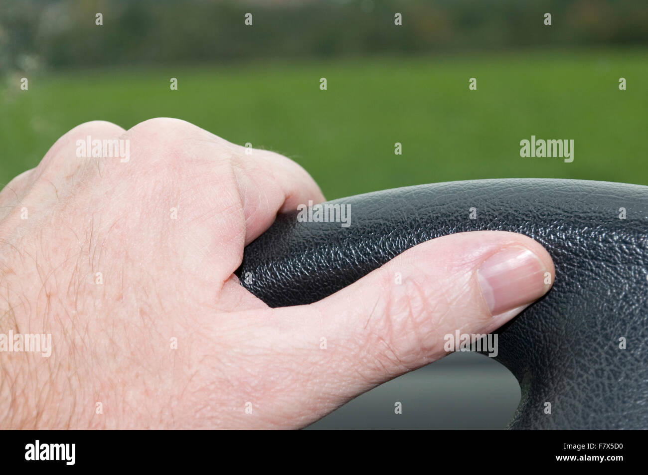 Hand on car steering wheel Stock Photo - Alamy