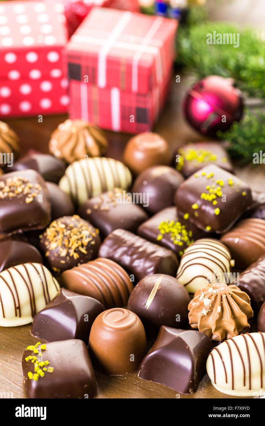 Wrapping assorted chocolates in small boxes for Christmas presents ...