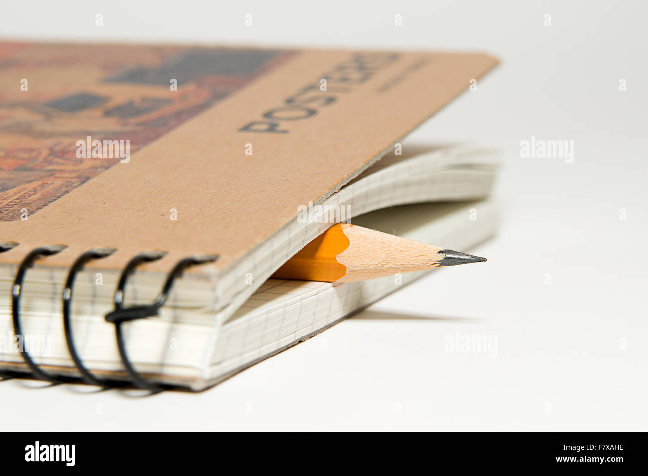 Closed notebook with a blank sheet and pencil on over white Stock Photo ...