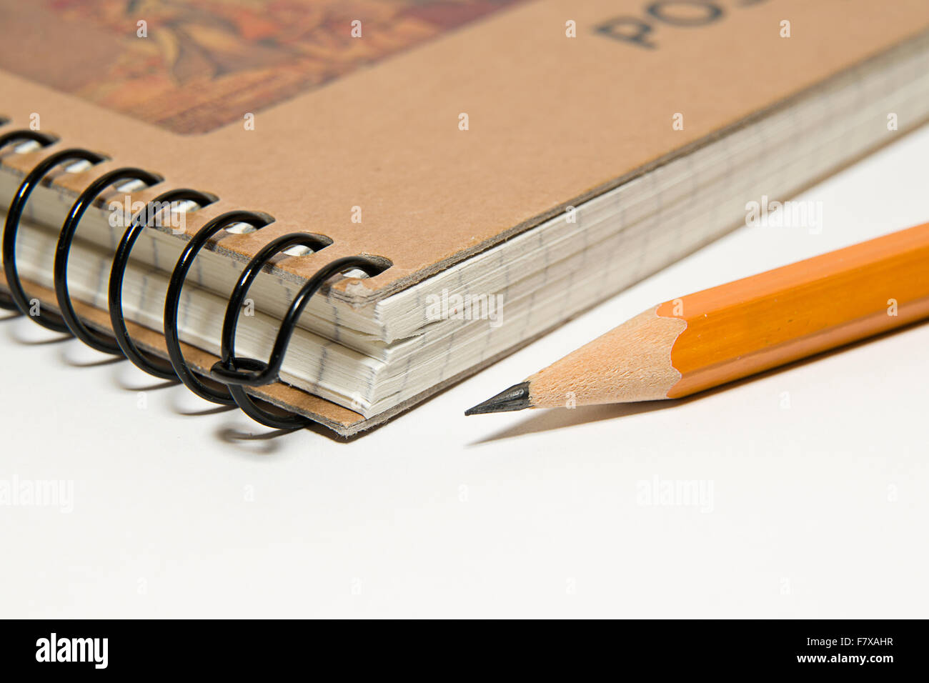 Closed notebook with a blank sheet and pencil on over white Stock Photo ...