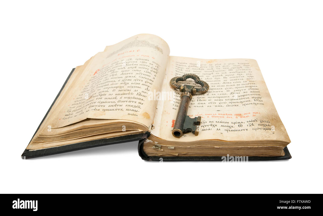 key placed on an 18st century vintage book, isolated on white Stock ...
