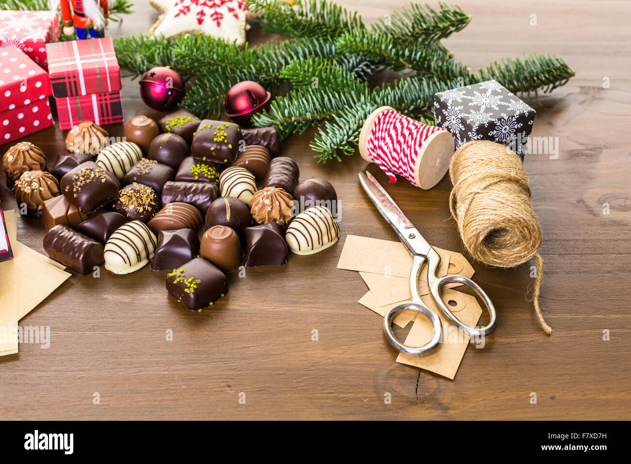 Wrapping assorted chocolates in small boxes for Christmas presents ...