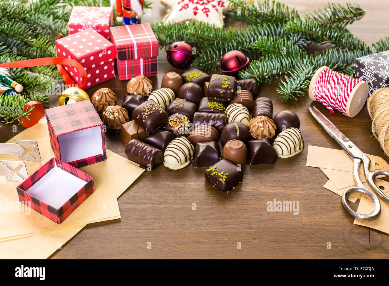 Wrapping assorted chocolates in small boxes for Christmas presents ...