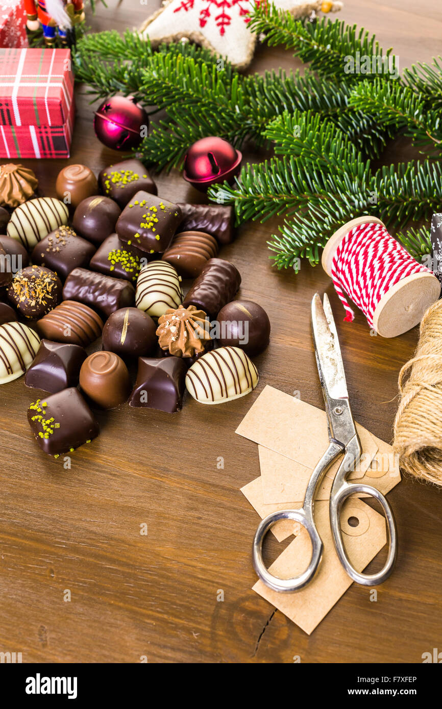Wrapping assorted chocolates in small boxes for Christmas presents ...