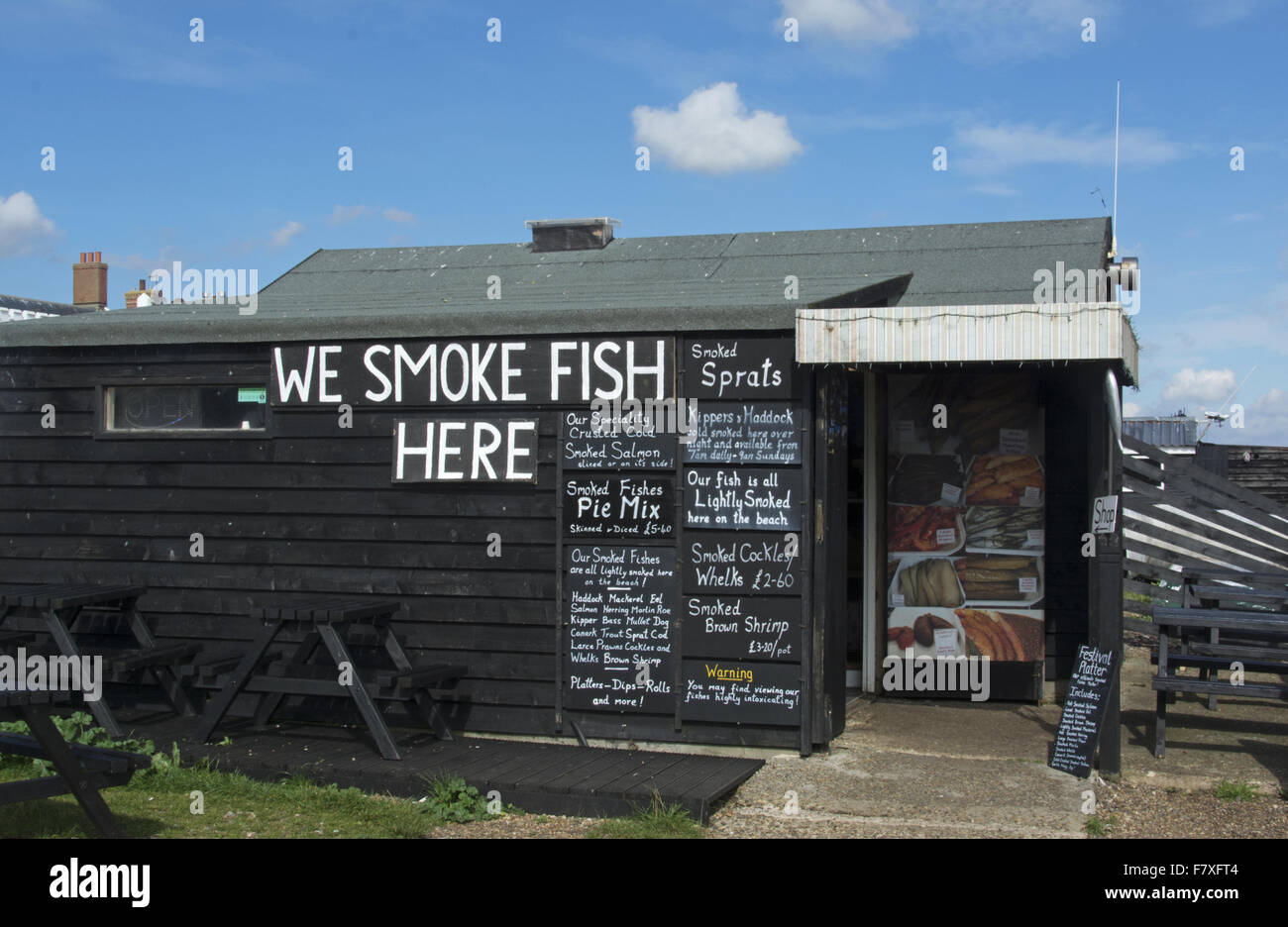 'We Smoke Fish Here' sign on shed at edge of beach, Aldeburgh, Suffolk ...