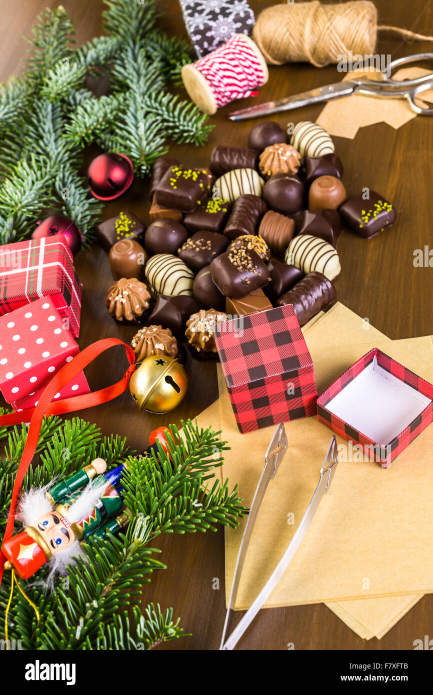 Wrapping assorted chocolates in small boxes for Christmas presents ...