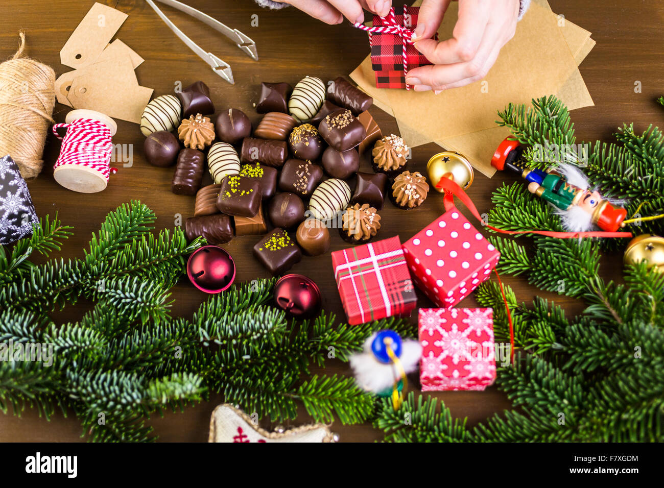 Wrapping assorted chocolates in small boxes for Christmas presents ...