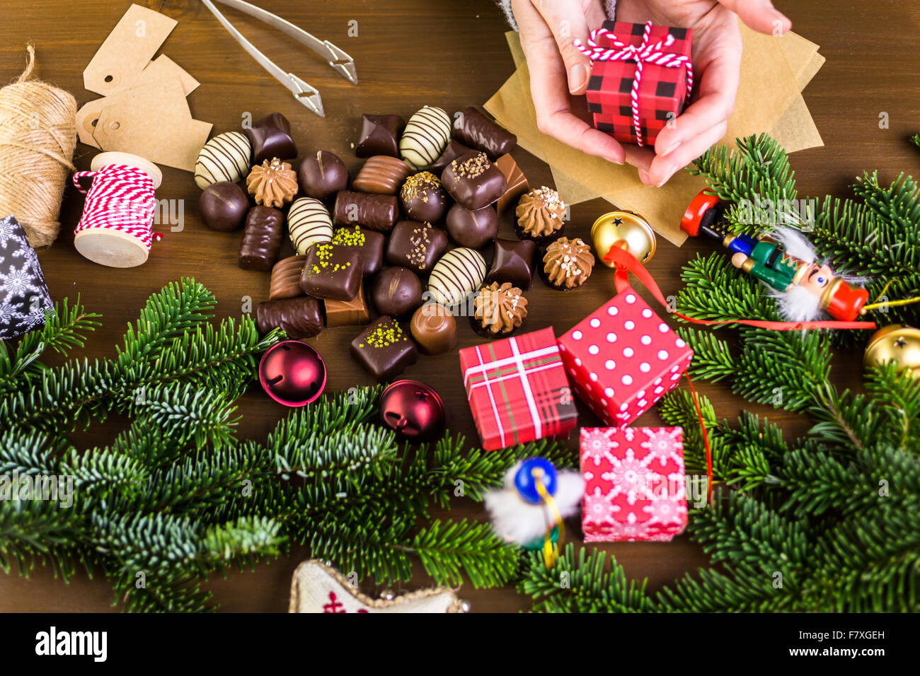 Wrapping assorted chocolates in small boxes for Christmas presents ...