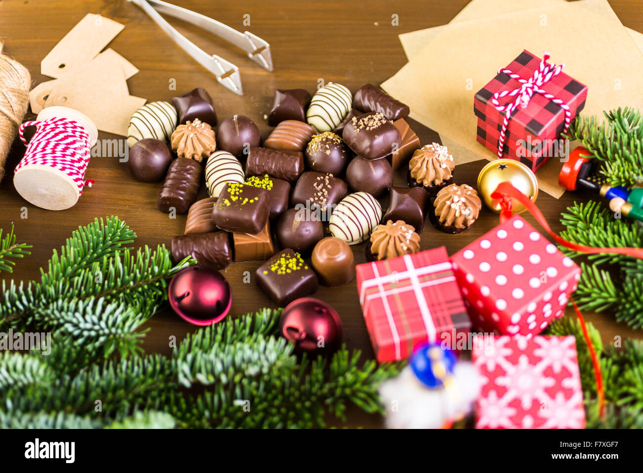 Wrapping assorted chocolates in small boxes for Christmas presents ...