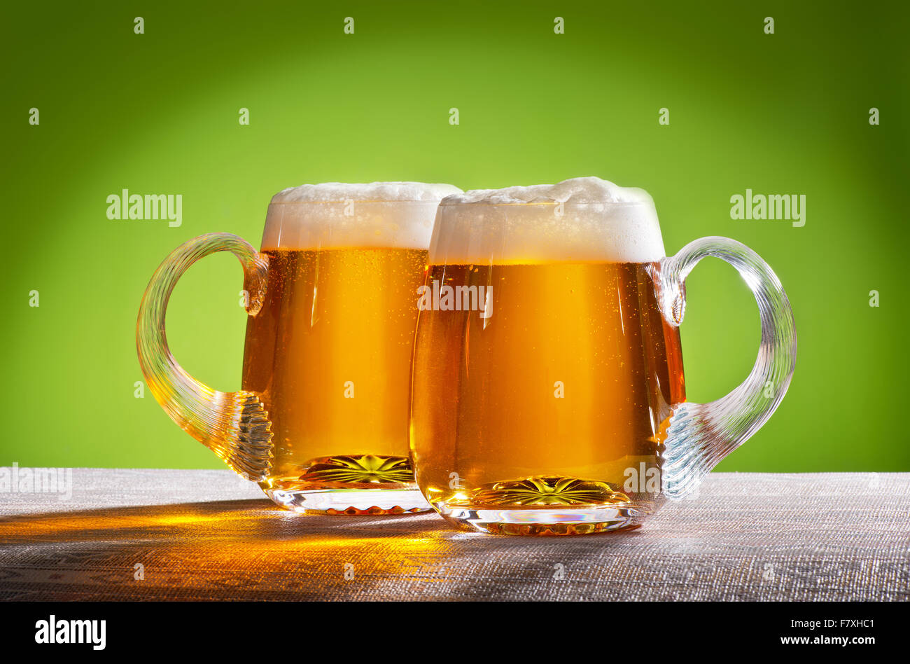 two beers on the table with green background Stock Photo - Alamy
