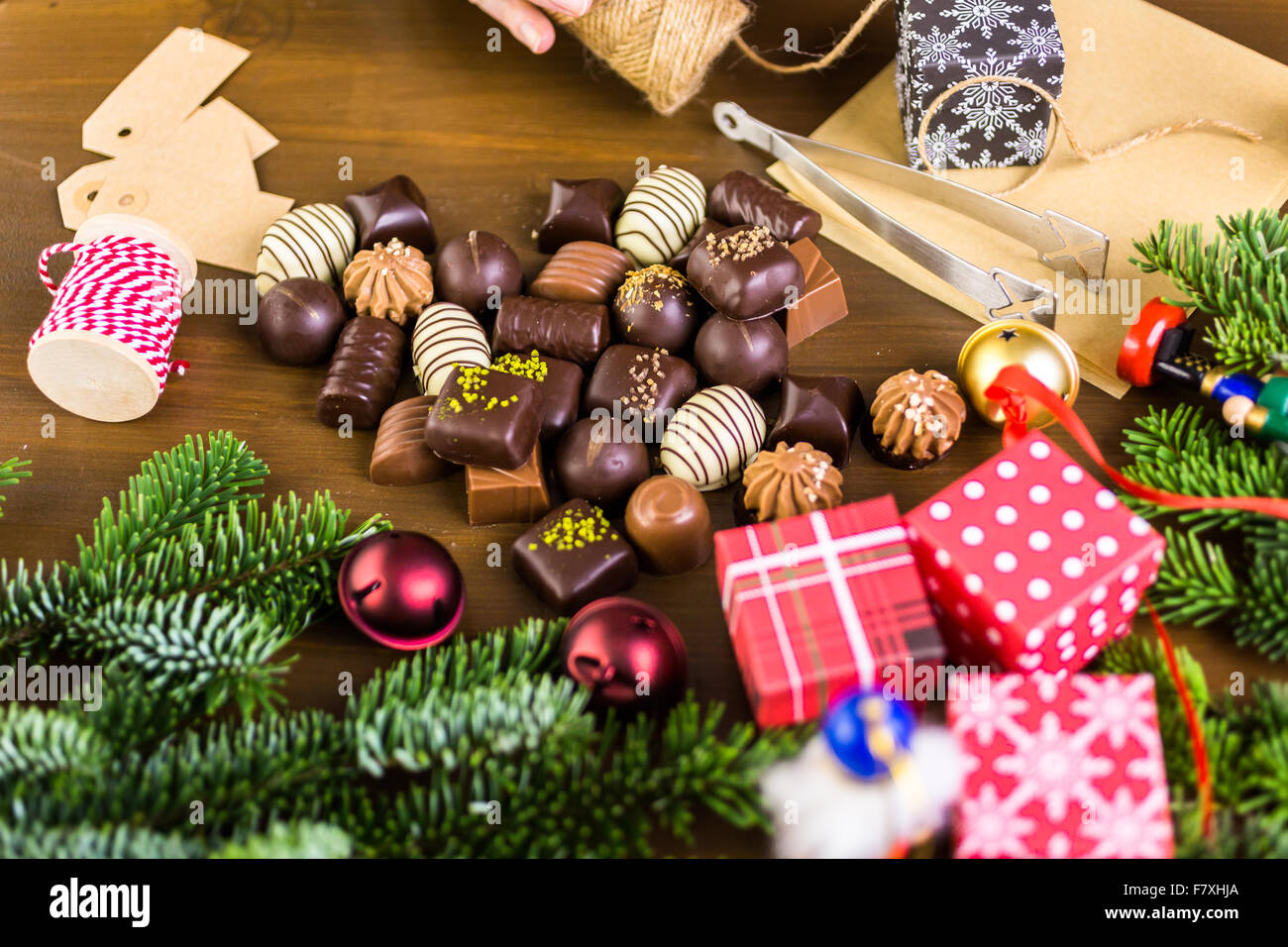 Wrapping assorted chocolates in small boxes for Christmas presents ...