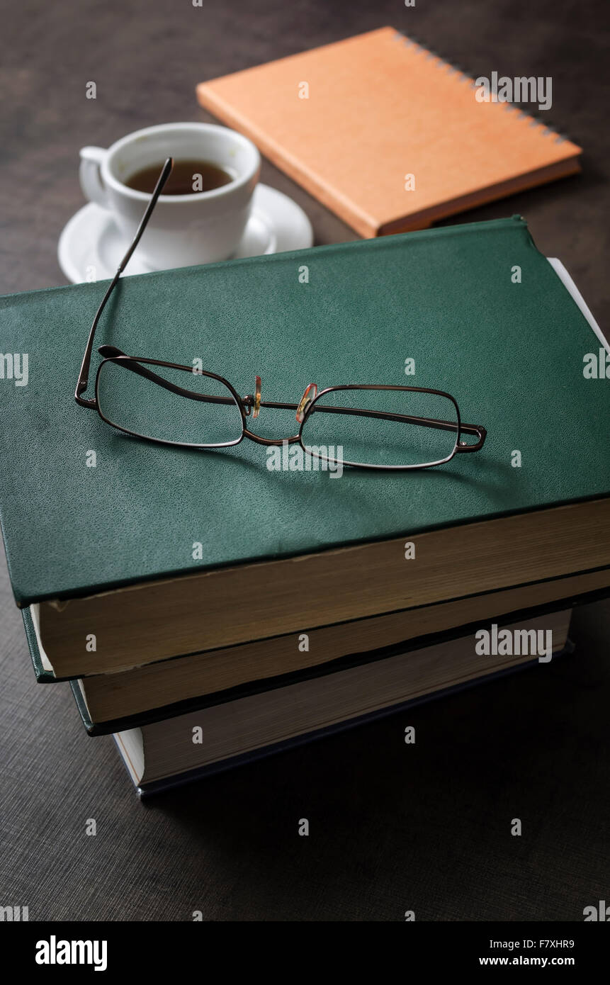 Stack of books and a pair of glasses on top of it. Close up Stock Photo ...
