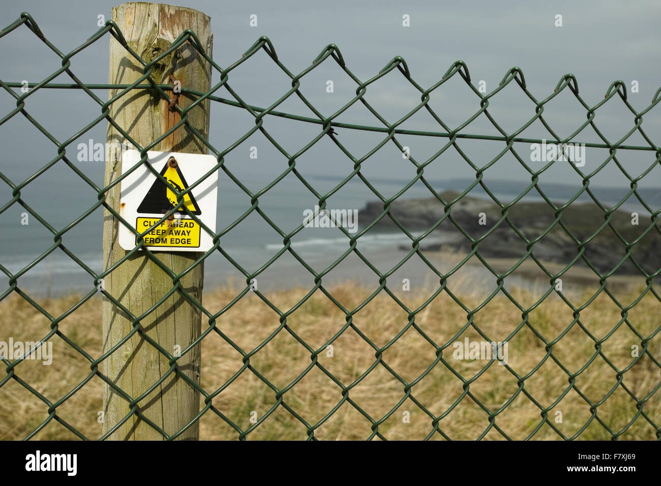 Sign and fence protect the public from danger on a cliff in Newquay ...