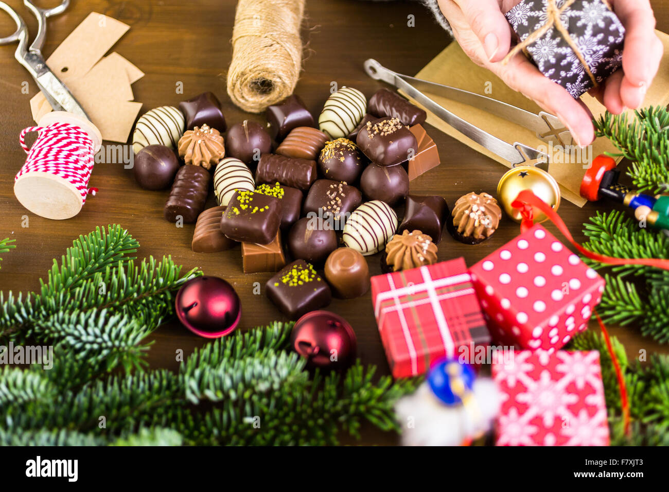 Wrapping assorted chocolates in small boxes for Christmas presents ...