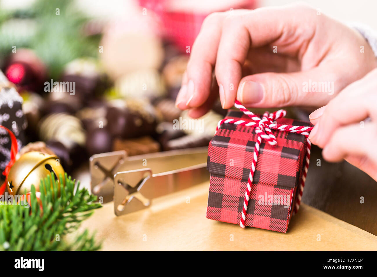 Wrapping assorted chocolates in small boxes for Christmas presents ...