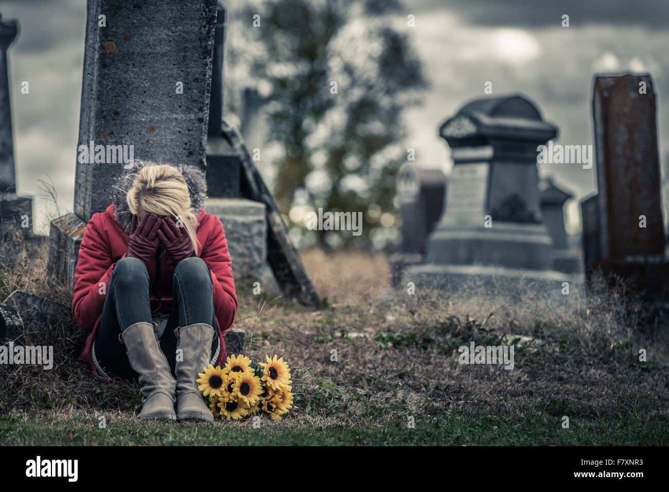 Lonely Crying Young Woman in Mourning with Sunflowers in front of a ...