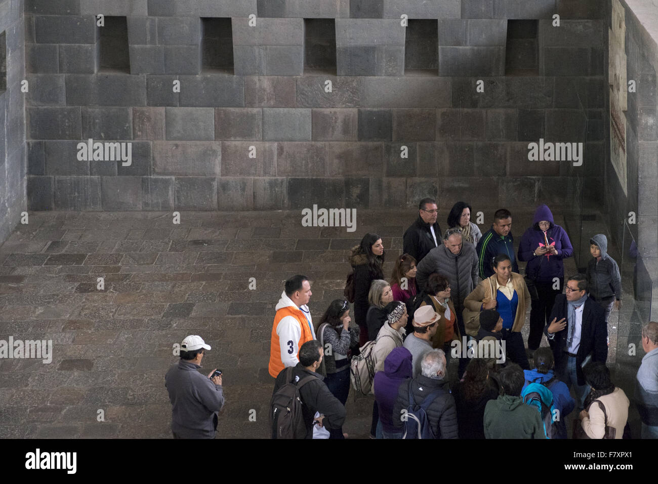 A group of tourists visit inside one of the buildings Inca temple ...