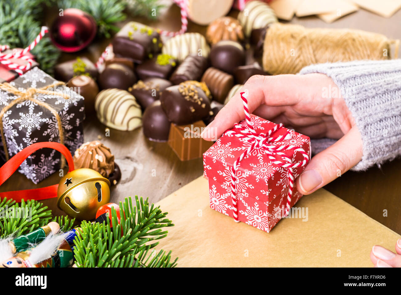 Wrapping assorted chocolates in small boxes for Christmas presents ...