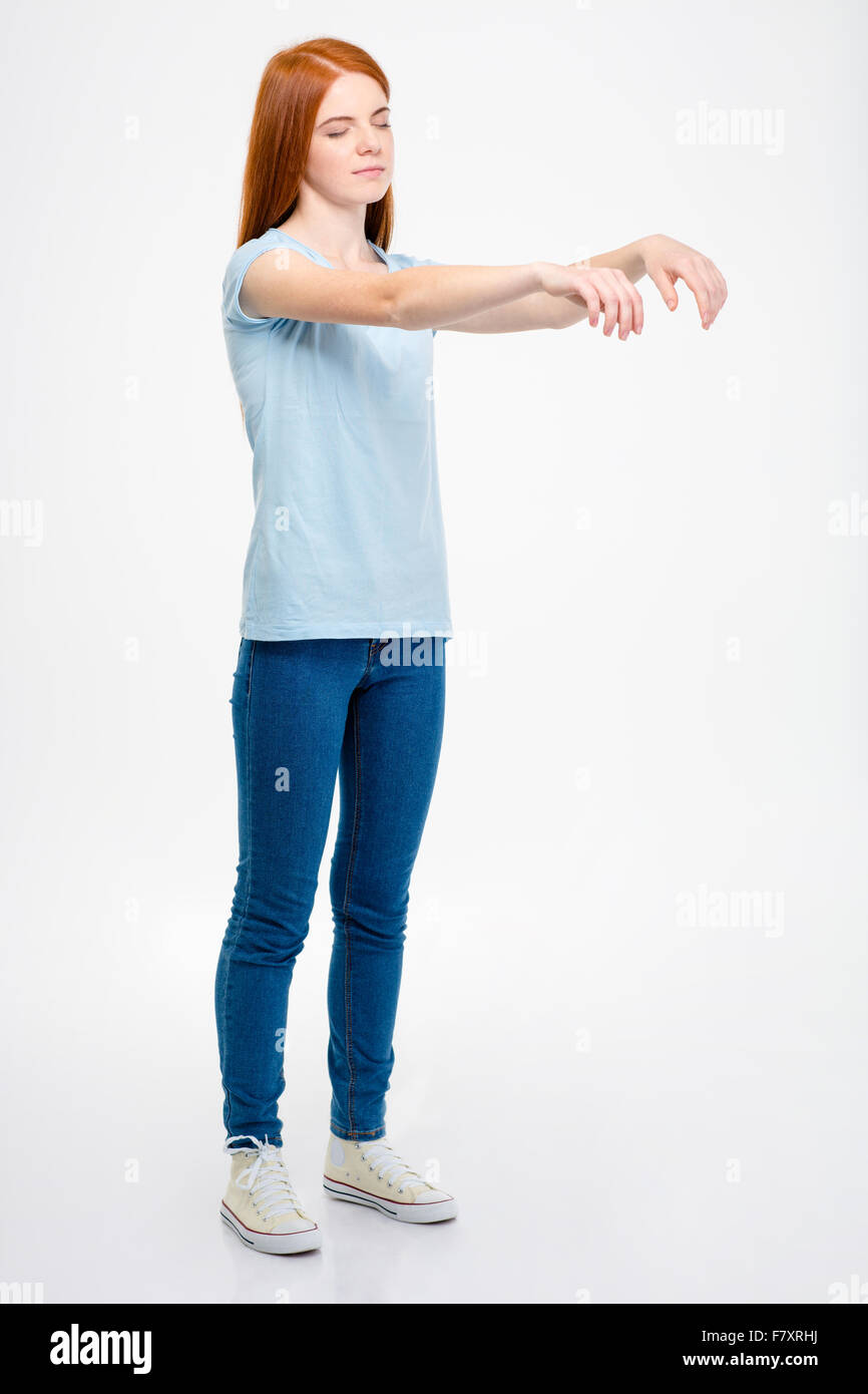 Full length of beautiful readhead sleepwalking young woman with long ...