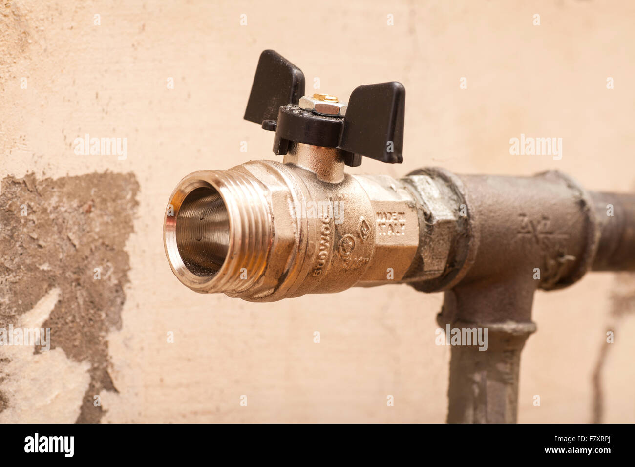 Plumbing pipe with valve for installation of a radiator Stock Photo - Alamy