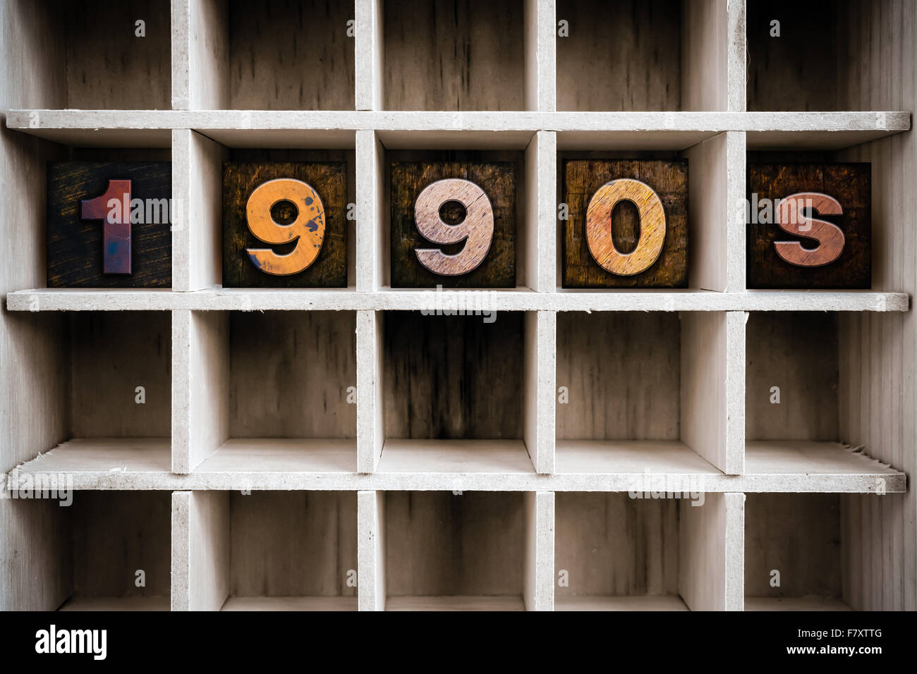 The word "1990s" written in vintage ink stained wooden letterpress type ...