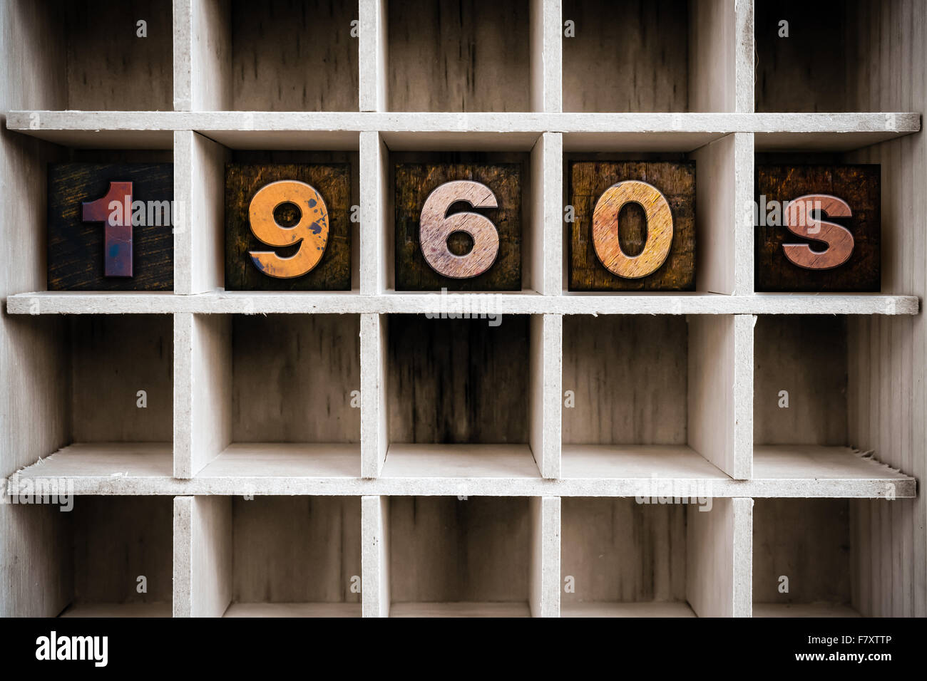 The word "1960s" written in vintage ink stained wooden letterpress type ...