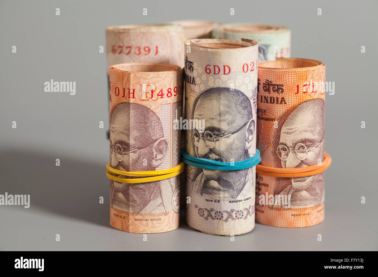 Rolls of Indian rupees isolated on gray background Stock Photo - Alamy