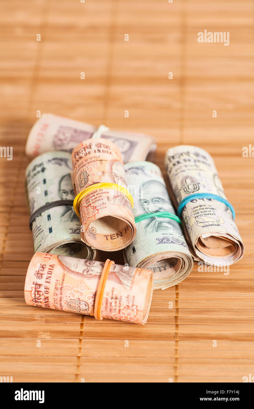 Rolls of Indian rupees on wooden background Stock Photo - Alamy