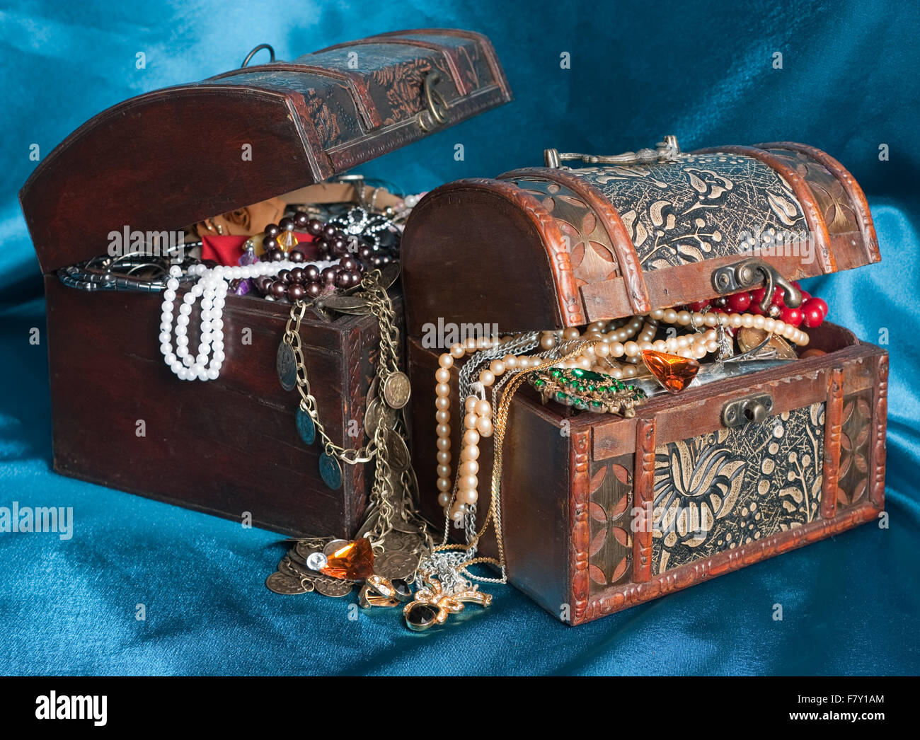 Two wooden treasure chests with valuables on blue textile Stock Photo ...