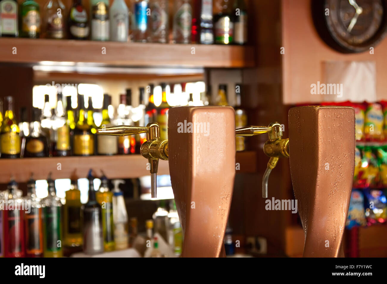 beer taps against alcohol counter in bar Stock Photo - Alamy