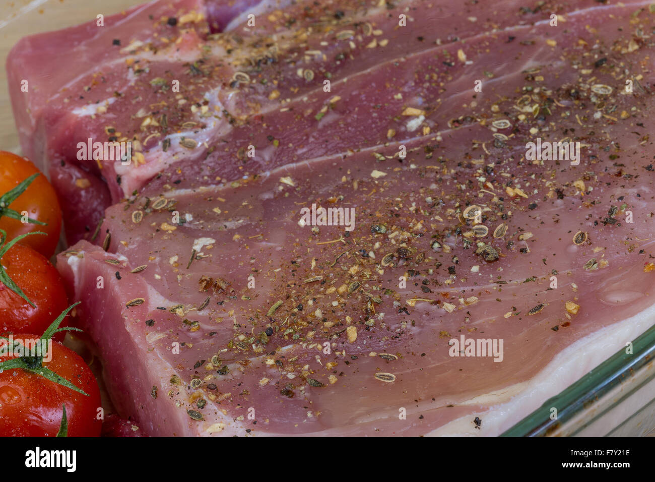 Raw pork meat ready for cooking with herbs Stock Photo - Alamy