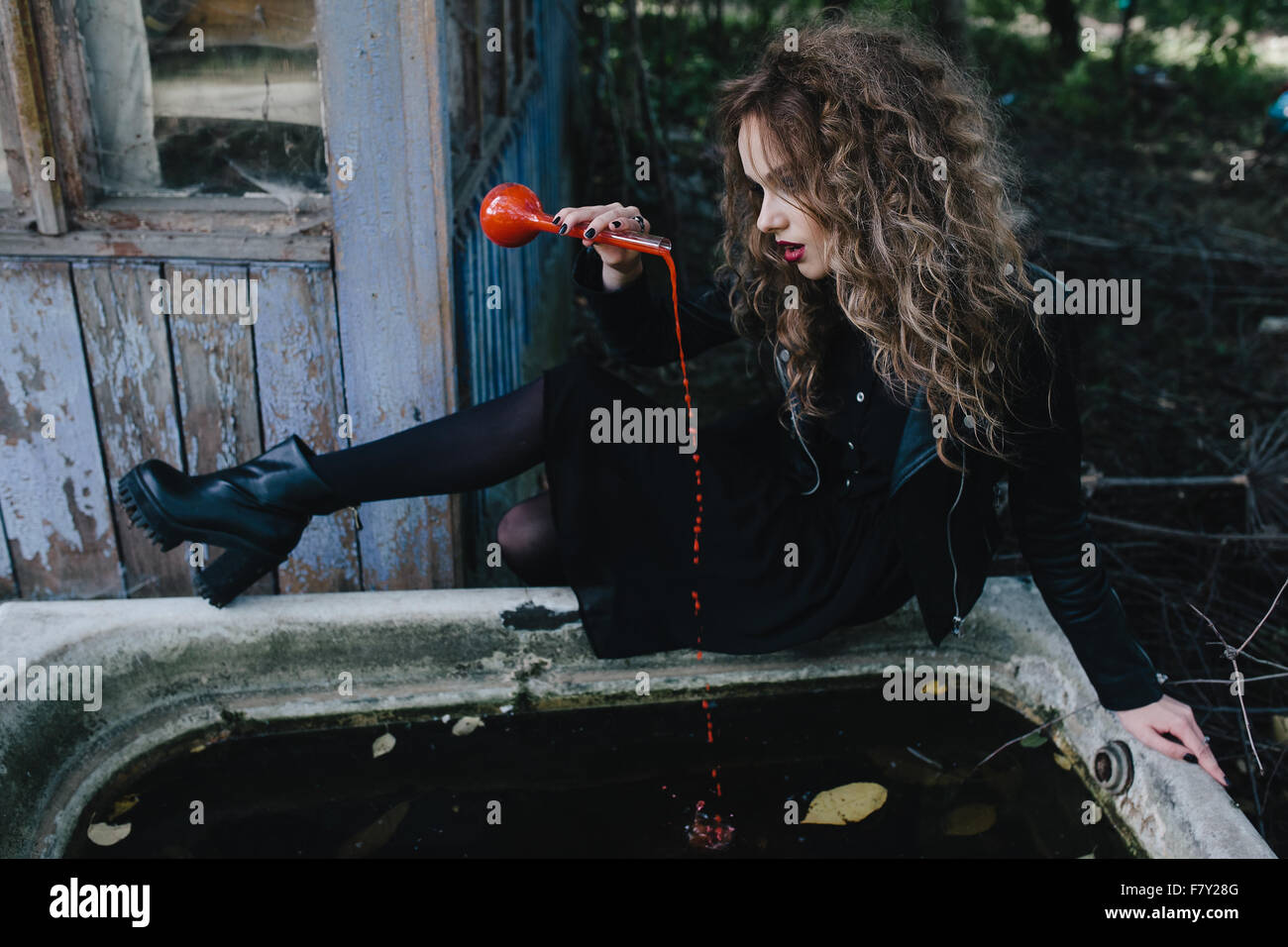 Vintage witch with elixir in hand Stock Photo - Alamy