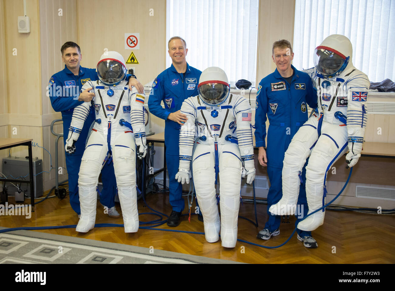 International Space Station Expedition 46 crew members hold their ...