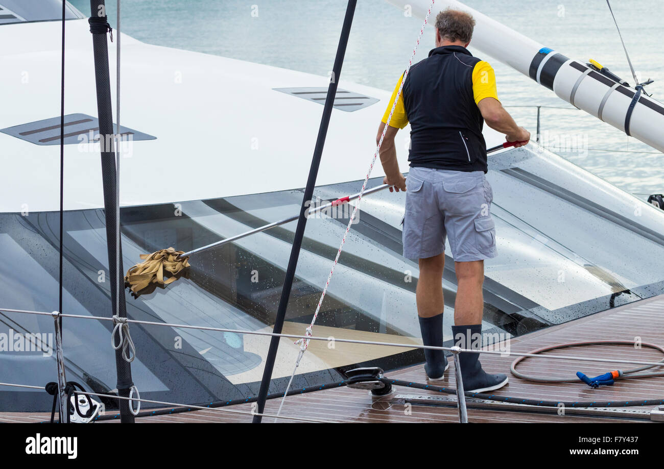 Crew cleaning windows on superyacht Stock Photo - Alamy
