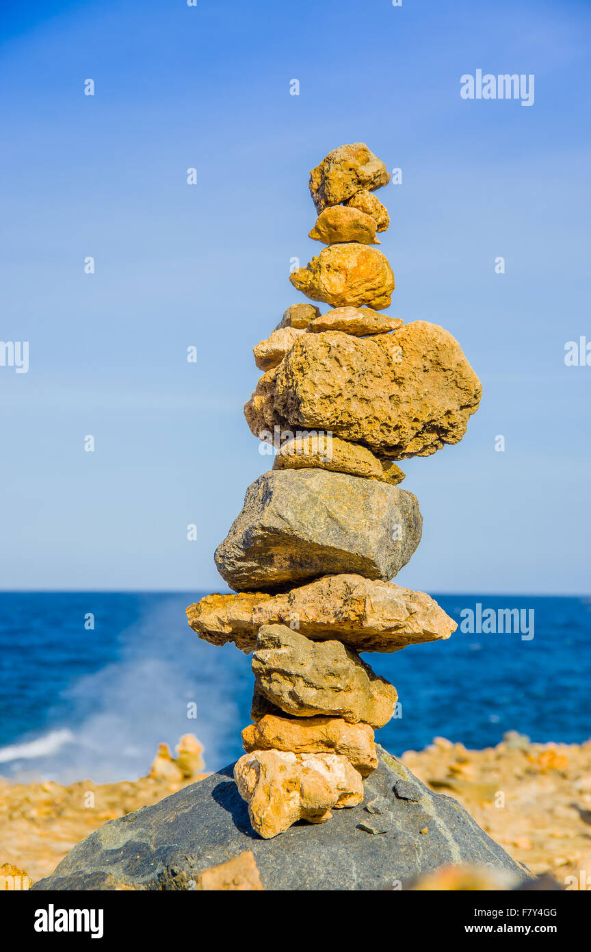 Stack of stones on sea shore, Aruba Stock Photo - Alamy