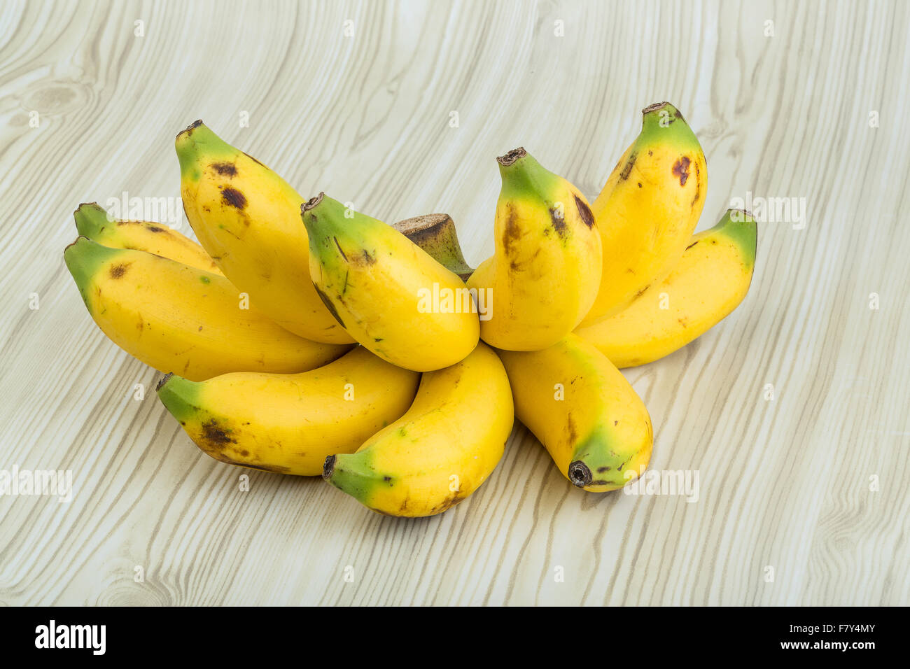 Fresh Baby bananas on the wood background Stock Photo - Alamy