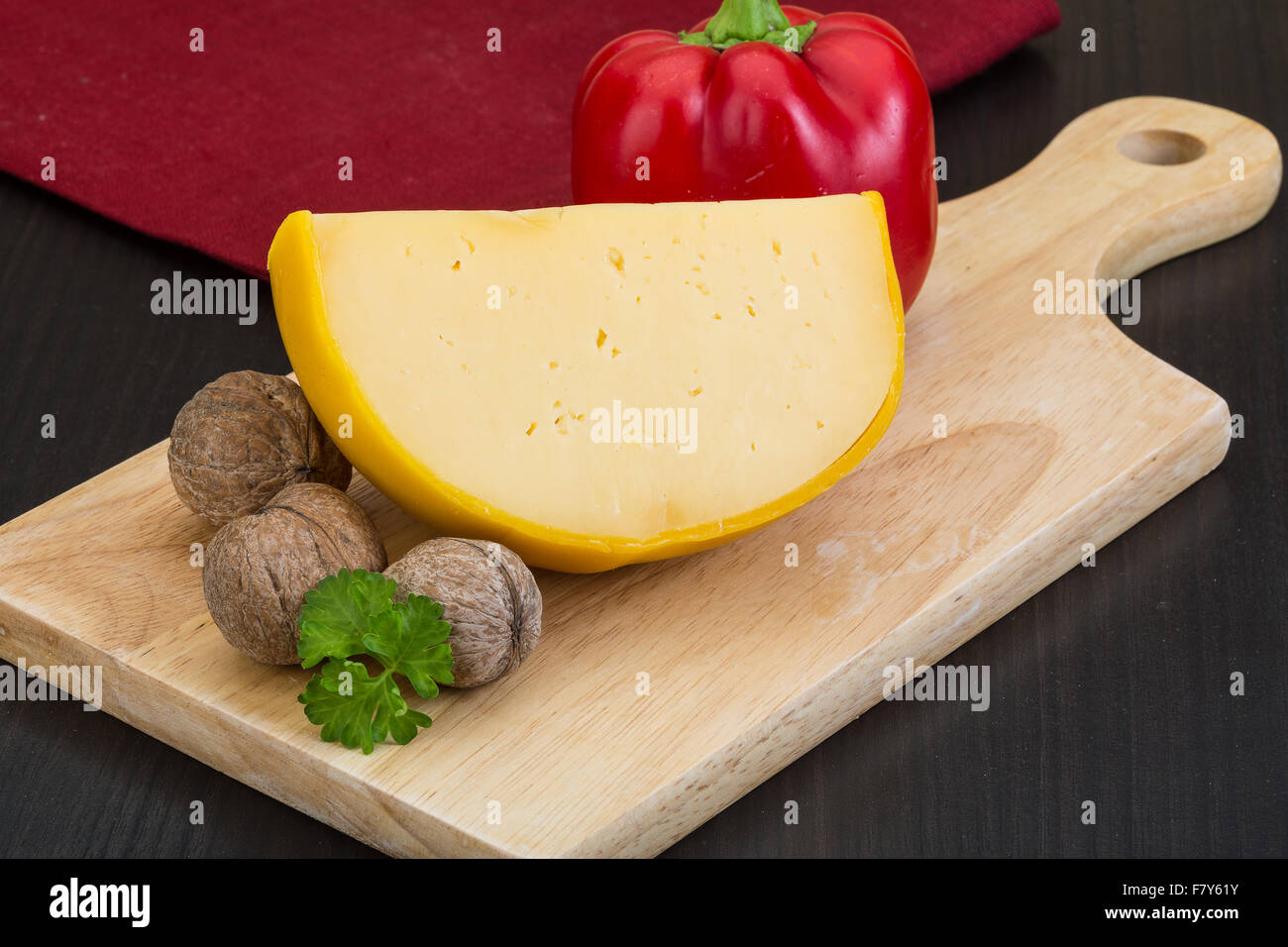 Yellow round cheese on the wood background Stock Photo - Alamy