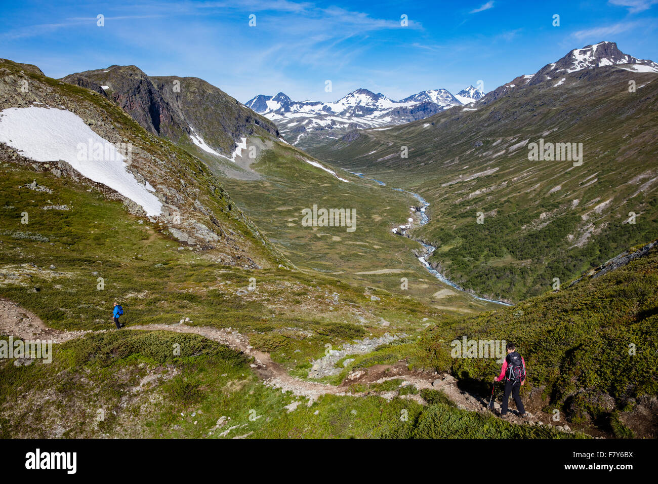 Two women hikers walking on the Memurubu to Gjendebu trail above ...