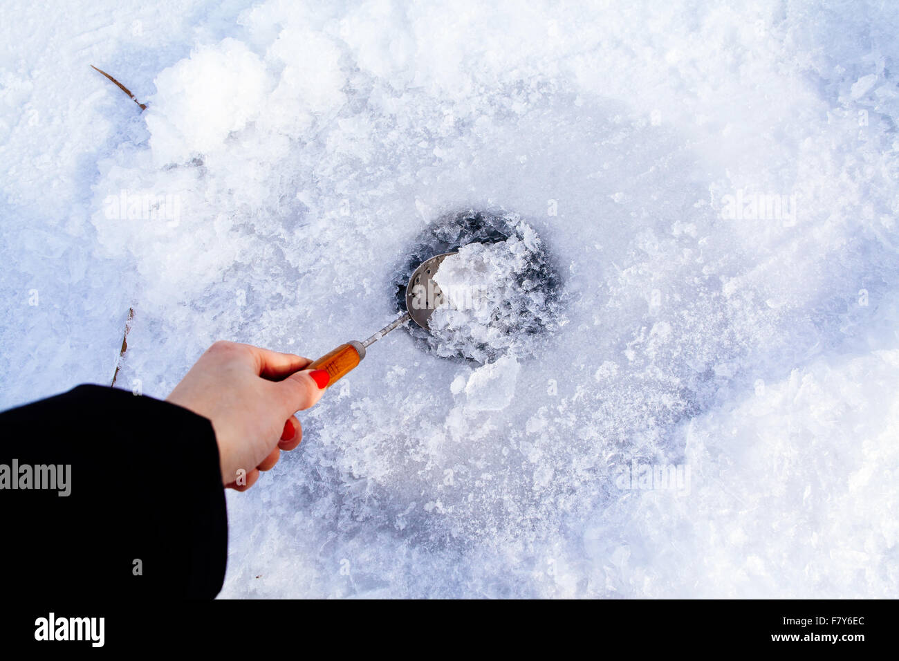 clean ice hole in frozen lake for winter fishing Stock Photo - Alamy