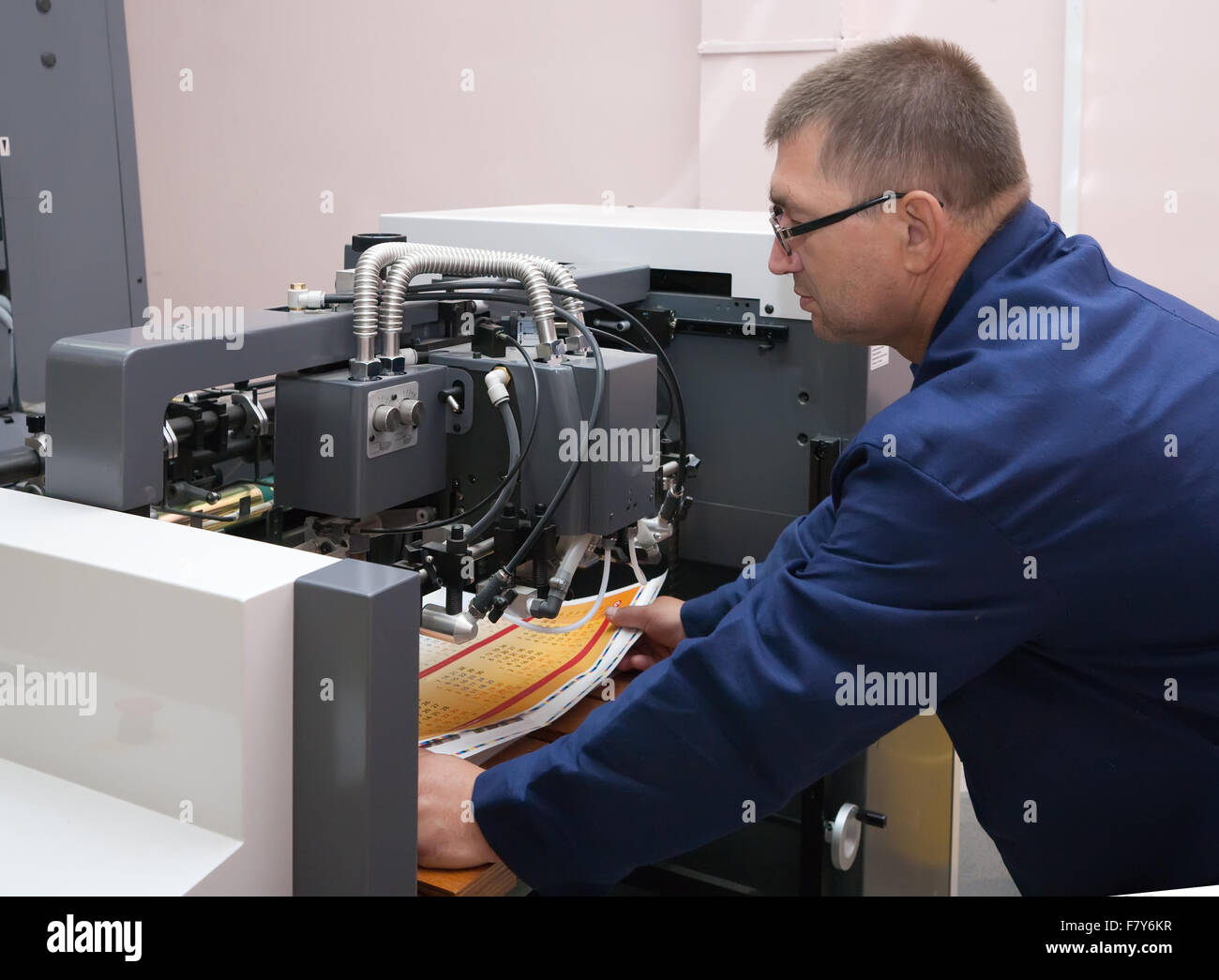Printer working at his new offset machine Stock Photo - Alamy