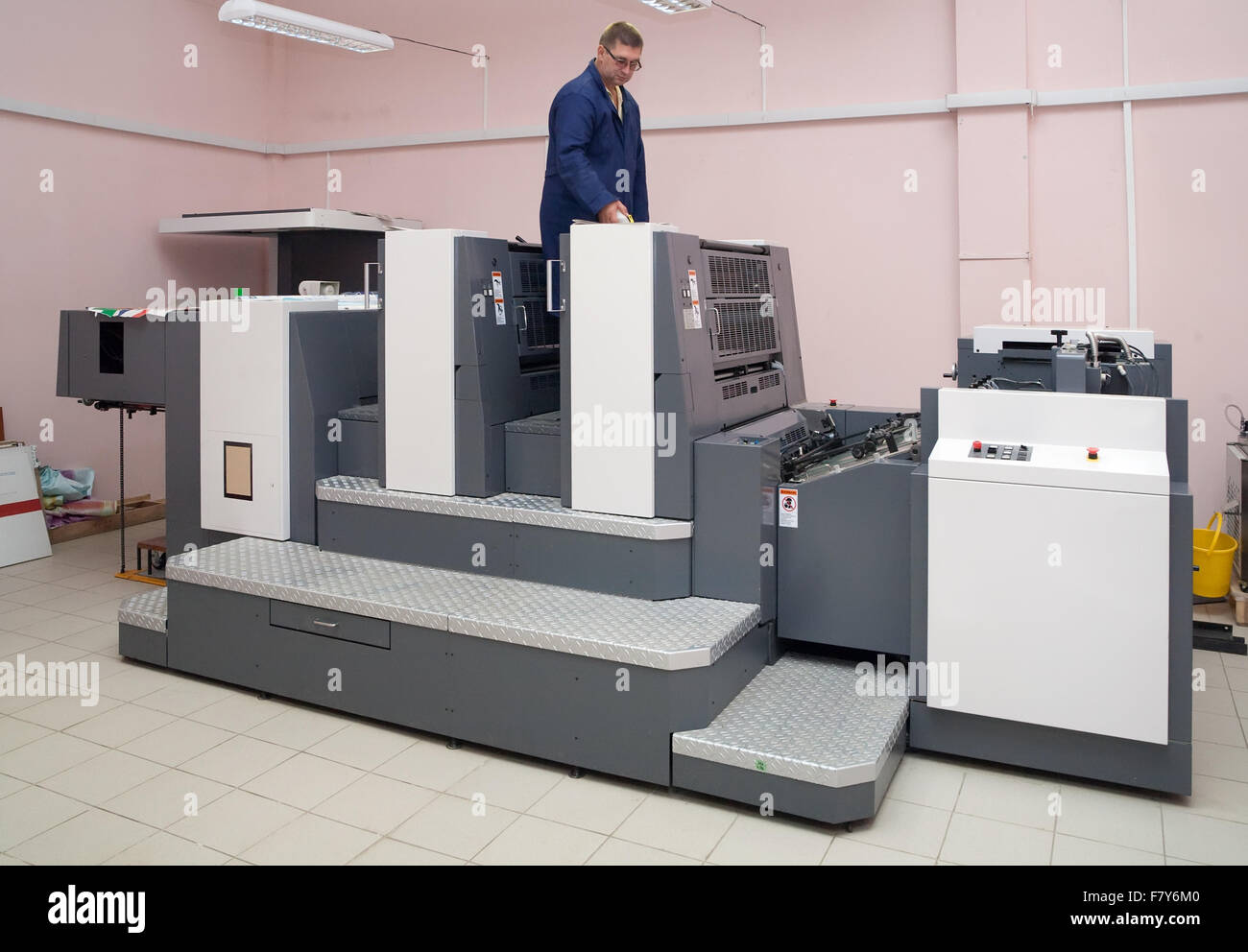Printer working at his two-section offset machine Stock Photo - Alamy
